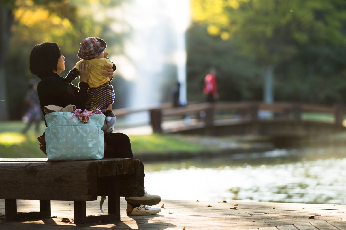 mother holding baby looking at | GANREF
