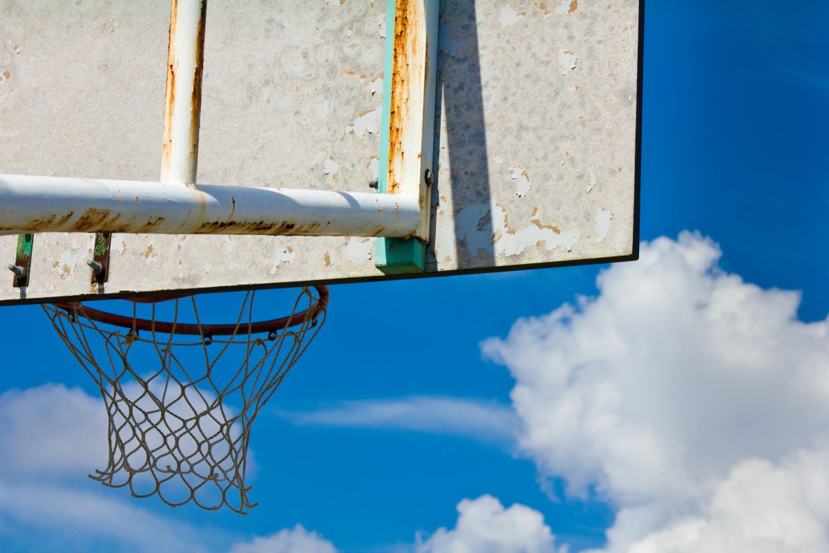 Behind the basketball goal | GANREF